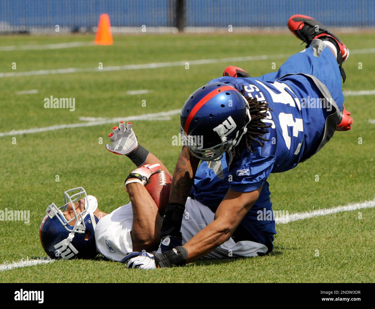 New York Giants' Chad Jones, right, goes over Victor Cruz at rookie NFL ...