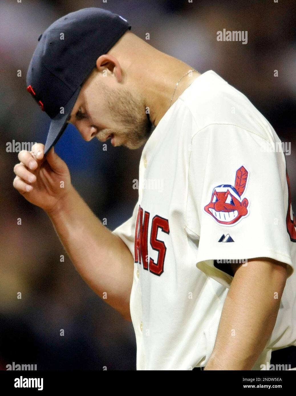 Cleveland Indians pitcher Justin Masterson tugs at his cap before being ...