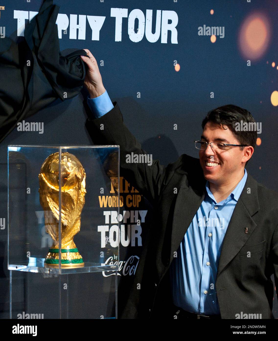 Reinaldo Padua of Coca-Cola unveils the FIFA World Cup trophy during a ...