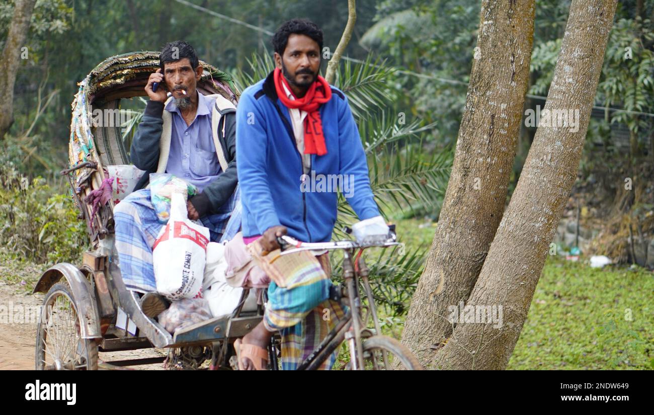 A rickshaw puller brings a passenger with a small, three-wheeled ...