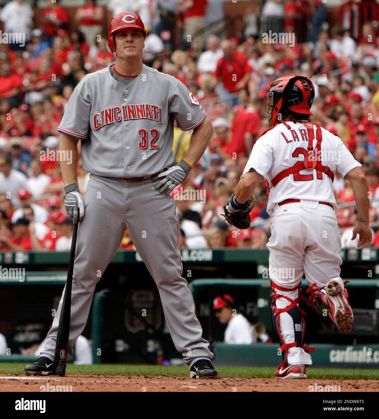 Cincinnati Reds' Jay Bruce, left, stands at the plate after being ...
