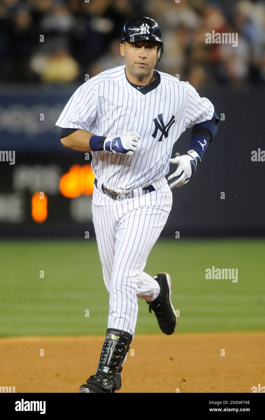 New York Yankees Derek Jeter rounds the bases after hitting a two-run ...