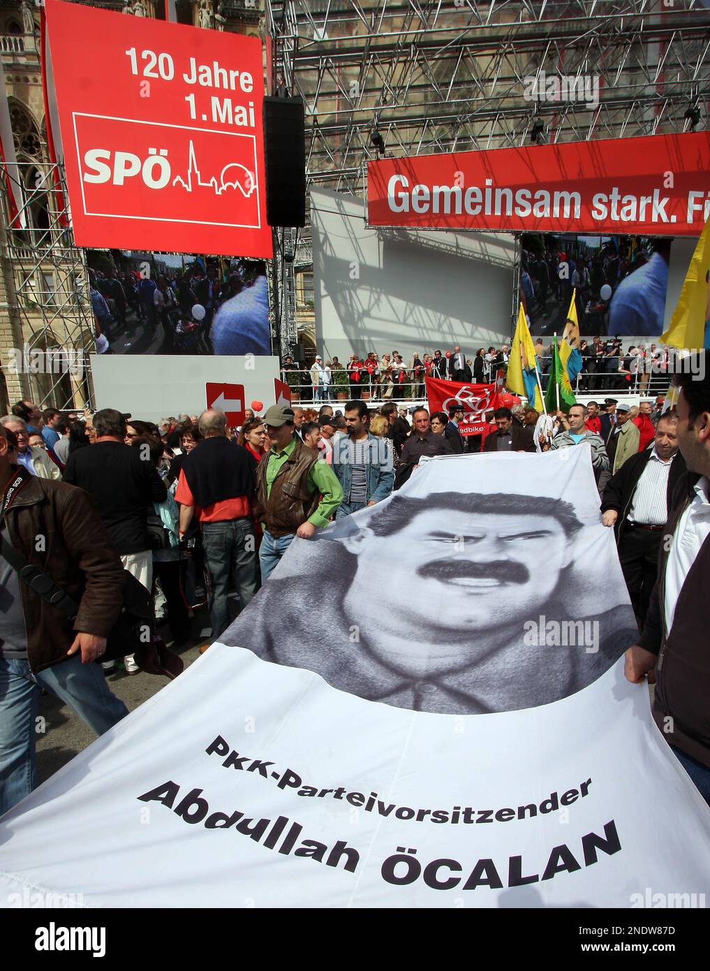 Kurds carry a banner with a portrait of PKK leader Abdullah Ocalan ...