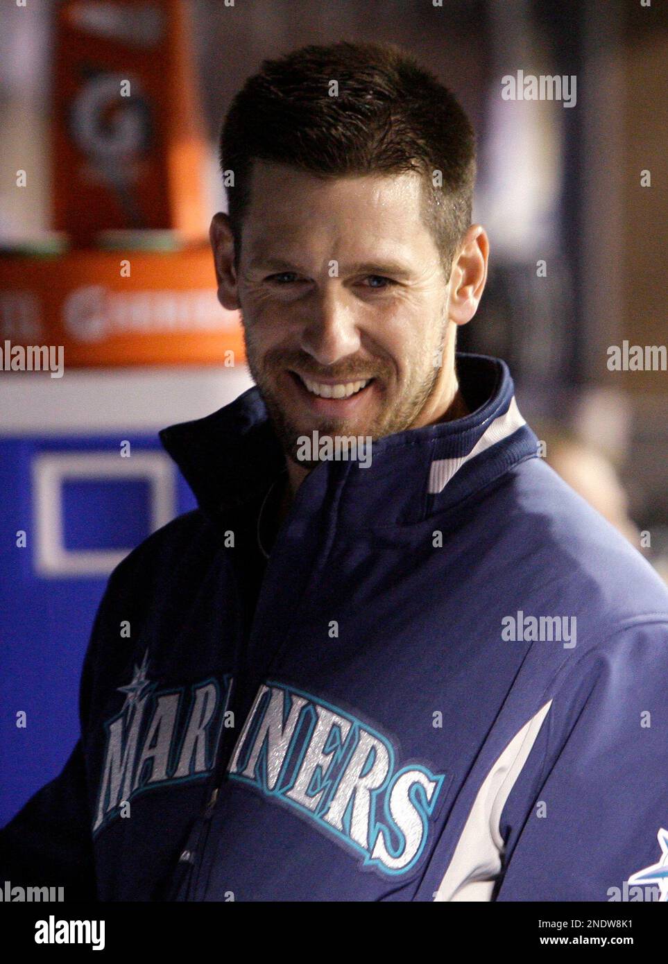 Seattle Mariners starting pitcher Cliff Lee smiles in the dugout after ...
