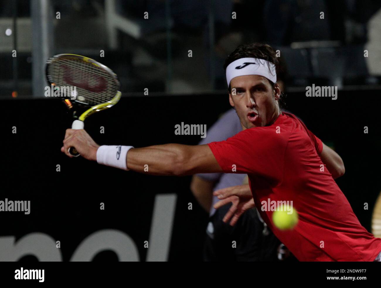 Feliciano Lopez of Spain returns the ball to Ernests Gulbis of Latvia ...