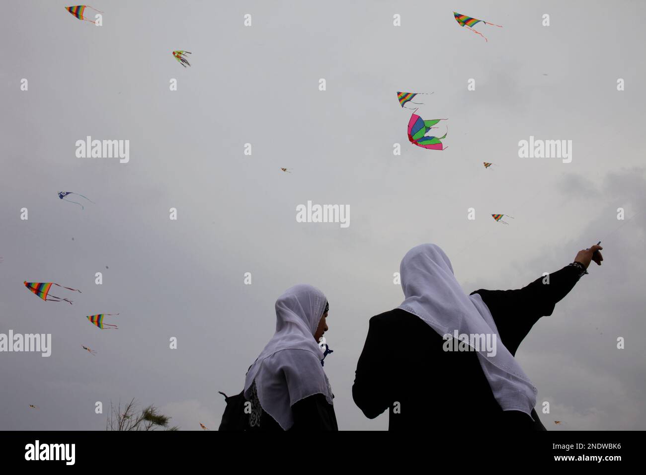 Israeli Arab women fly kites during an opening of a new public park in ...
