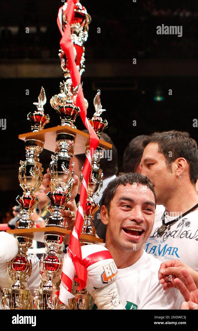 Mexico's Fernando Montiel celebrates with a trophy after his victory ...