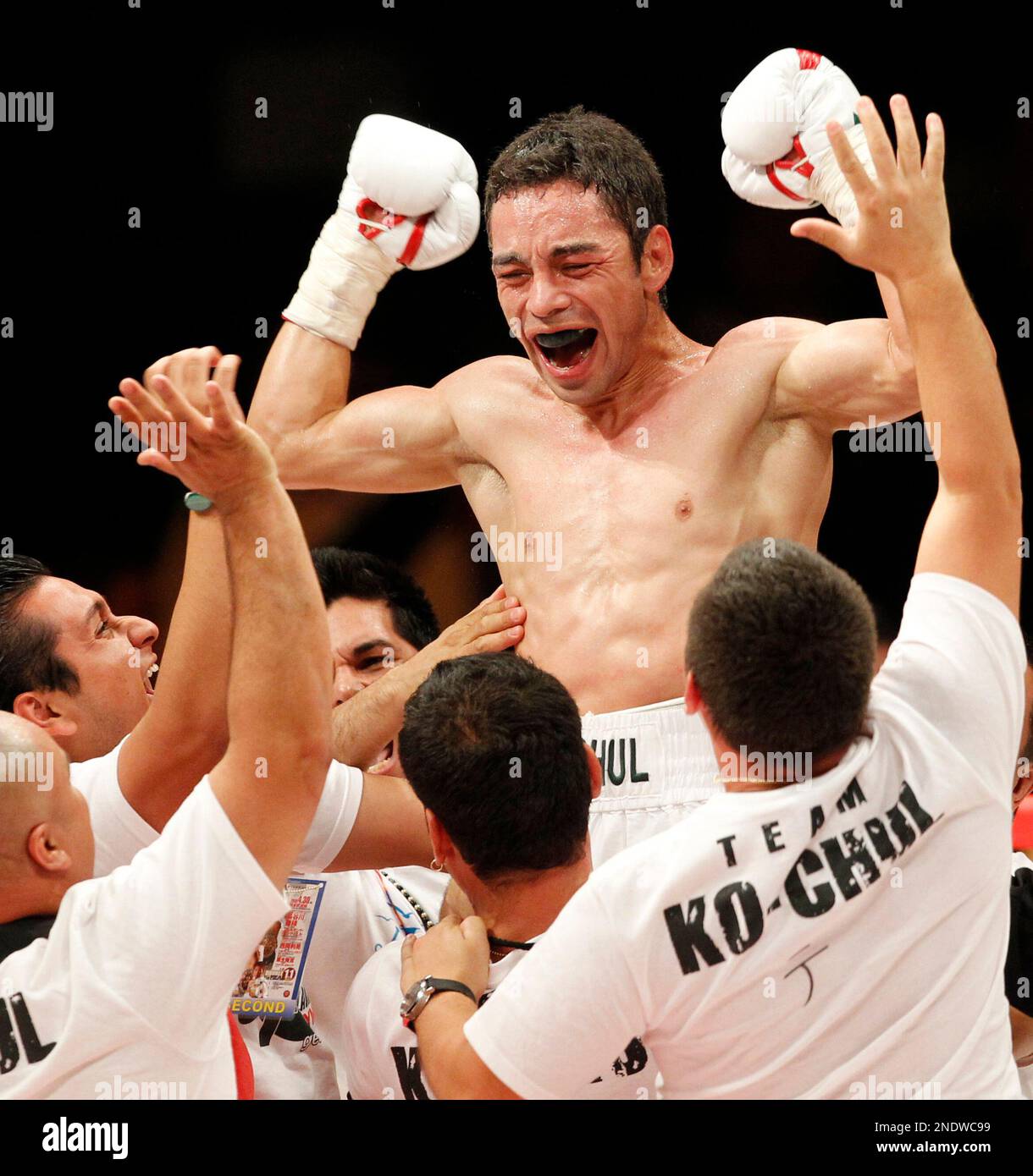 Mexican WBO champion Fernando Montiel celebrates with his corner's men ...