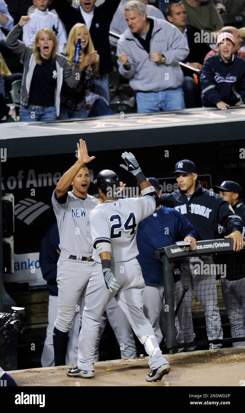New York Yankees' Robinson Cano (24) celebrates his home run with Alex ...