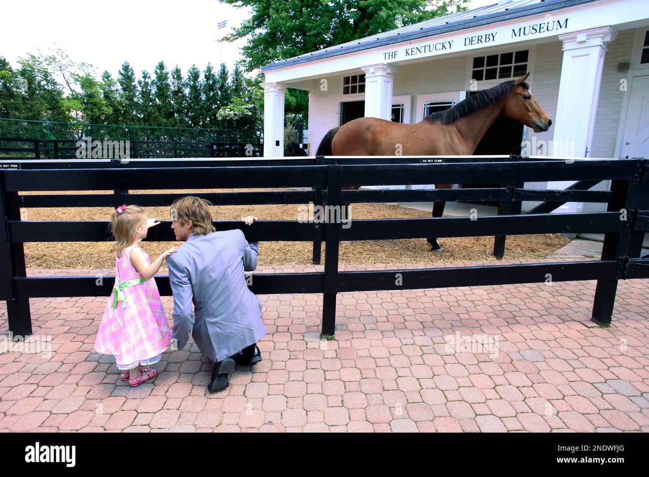 Larry Berkhead and daughter Dannielynn look at a horse at the Kentucky ...