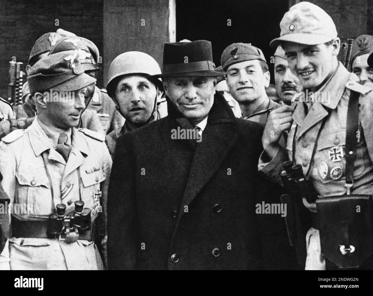 Italian dictator Benito Mussolini, centre, leaves the Gran Sasso Hotel ...