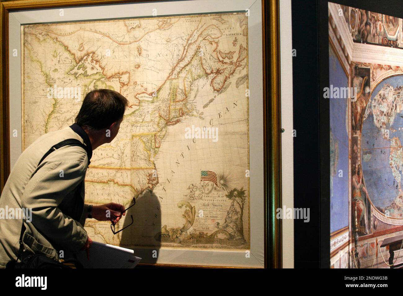 A visitor looks at an American Independent map on display in an ...