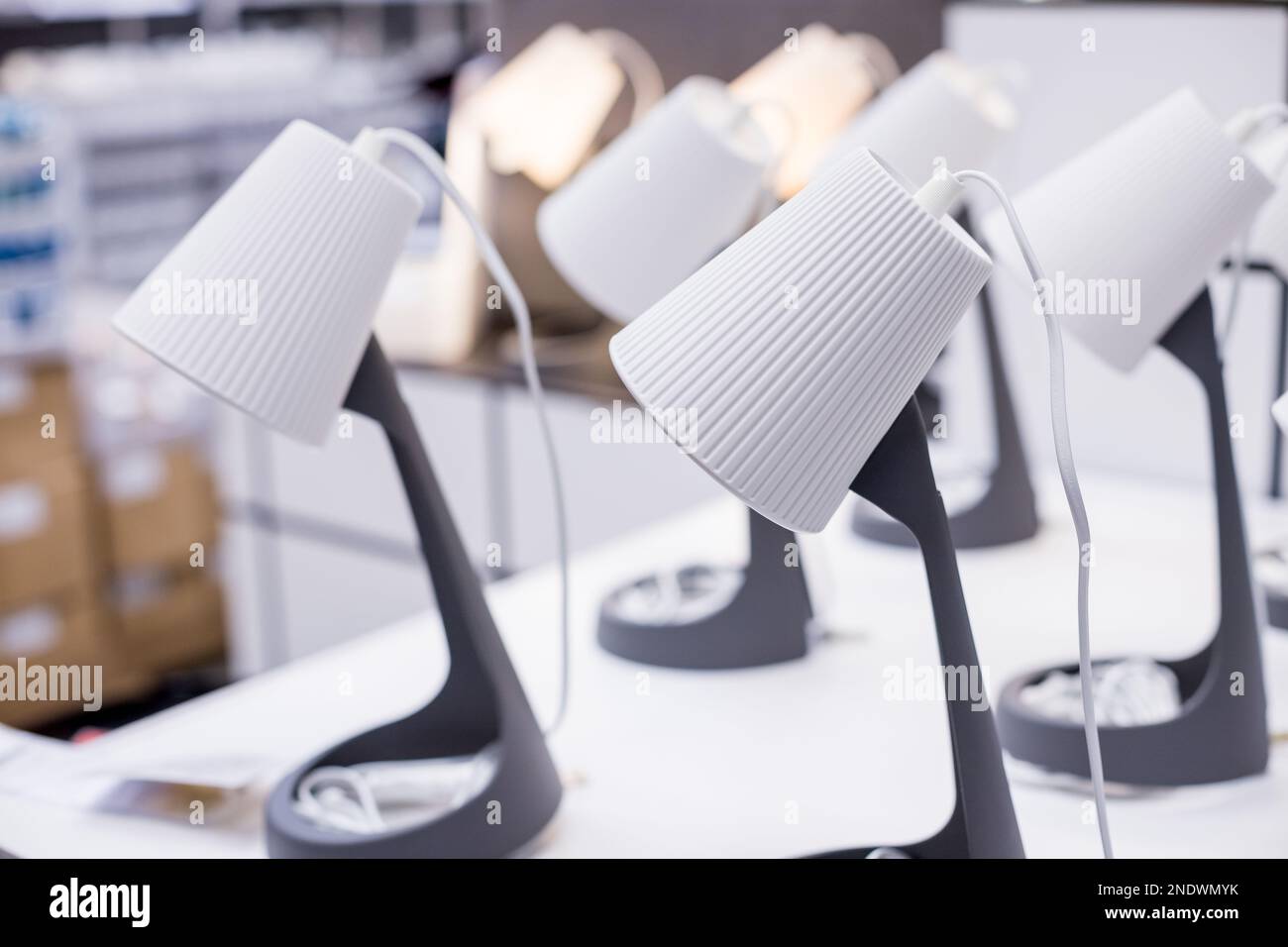 adjustable white mini small LED desk table lamp shining light on white ...