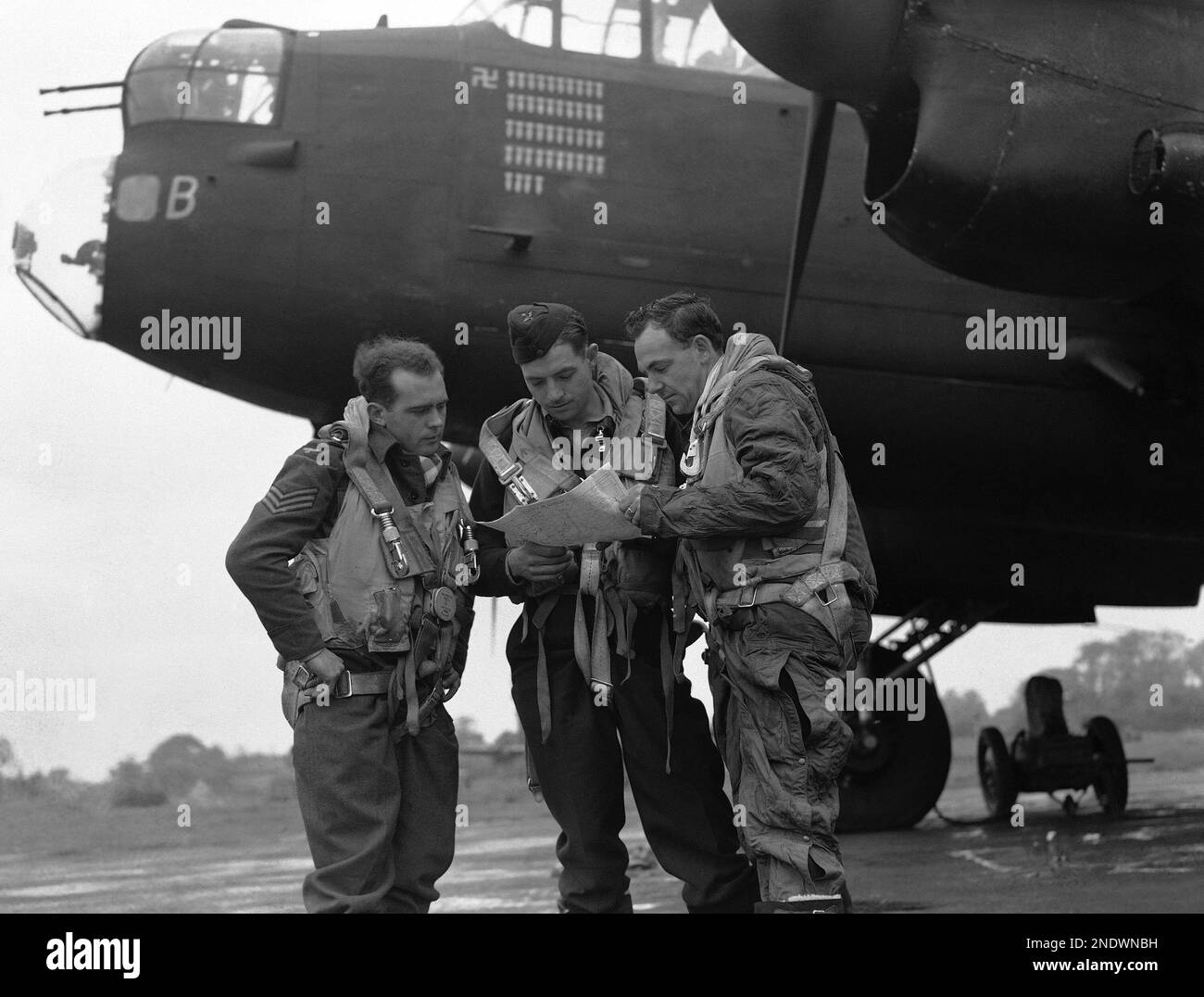 Crew members of a British Lancaster bomber discuss the daylight bombing ...