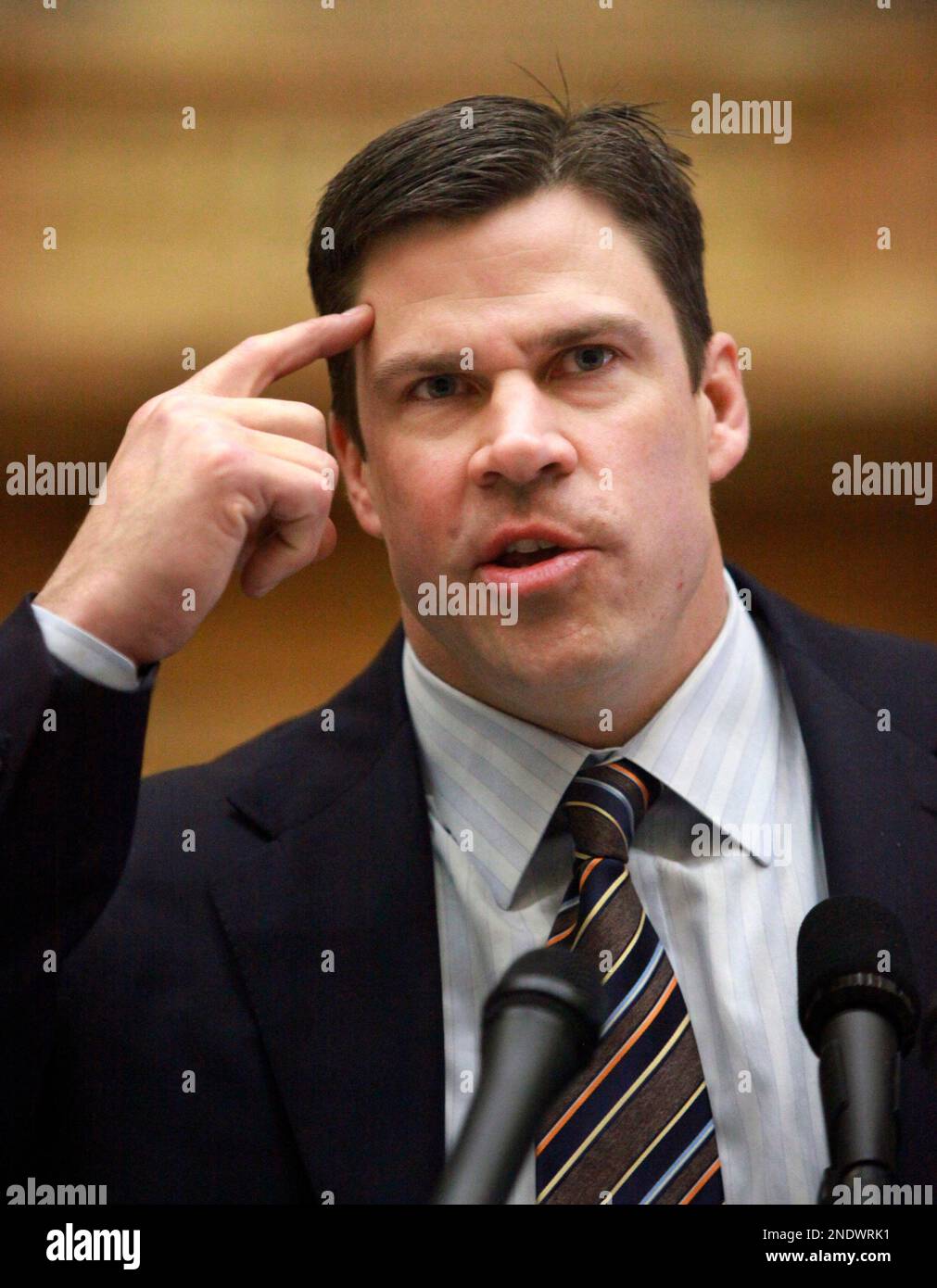 Former New England Patriots linebacker Ted Johnson, points to his head ...