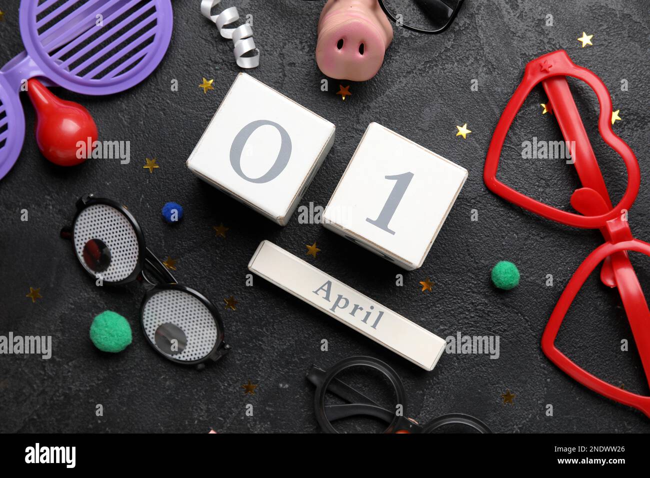 Date 1 APRIL with party decor for Fools' Day celebration on dark ...