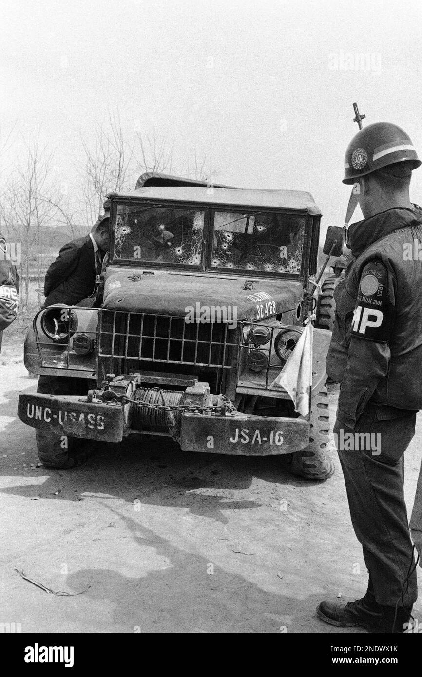 An American military policeman stands guard beside a U.S. Army truck ...