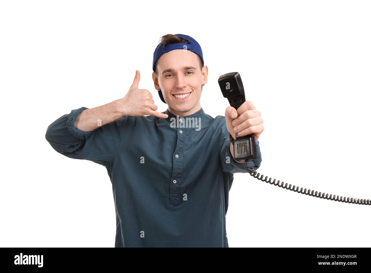 Cool young man with phone receiver showing "call me" gesture on white ...