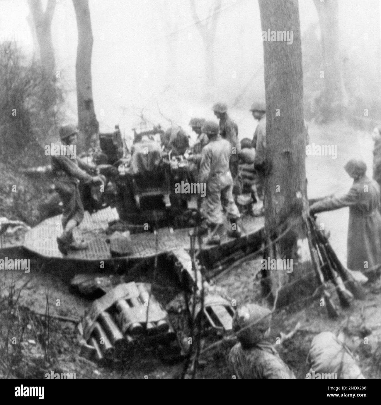 American troops in Belgium man a 90mm. anti-aircraft gun as an anti ...