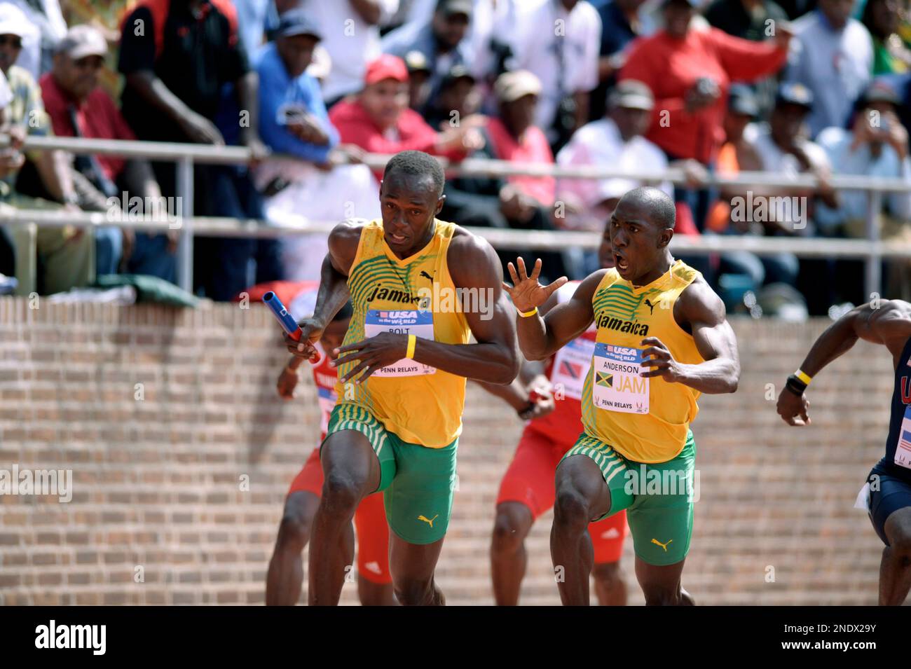 Jamaican sprinter Usain Bolt, left, takes the hand off from teammate ...
