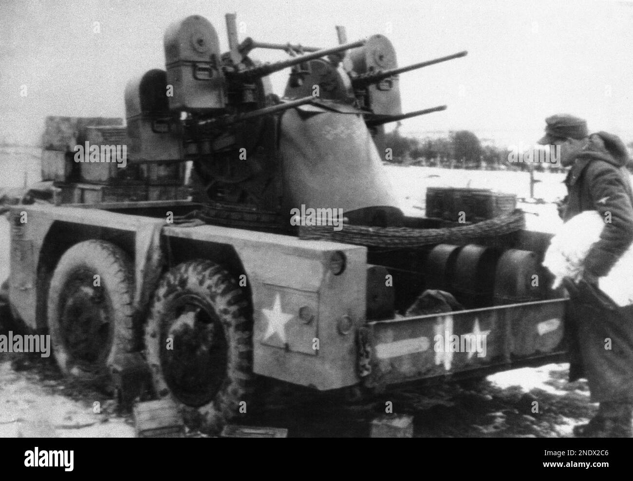A German soldier inspects an American “Flak Wagon” captured by Germans ...