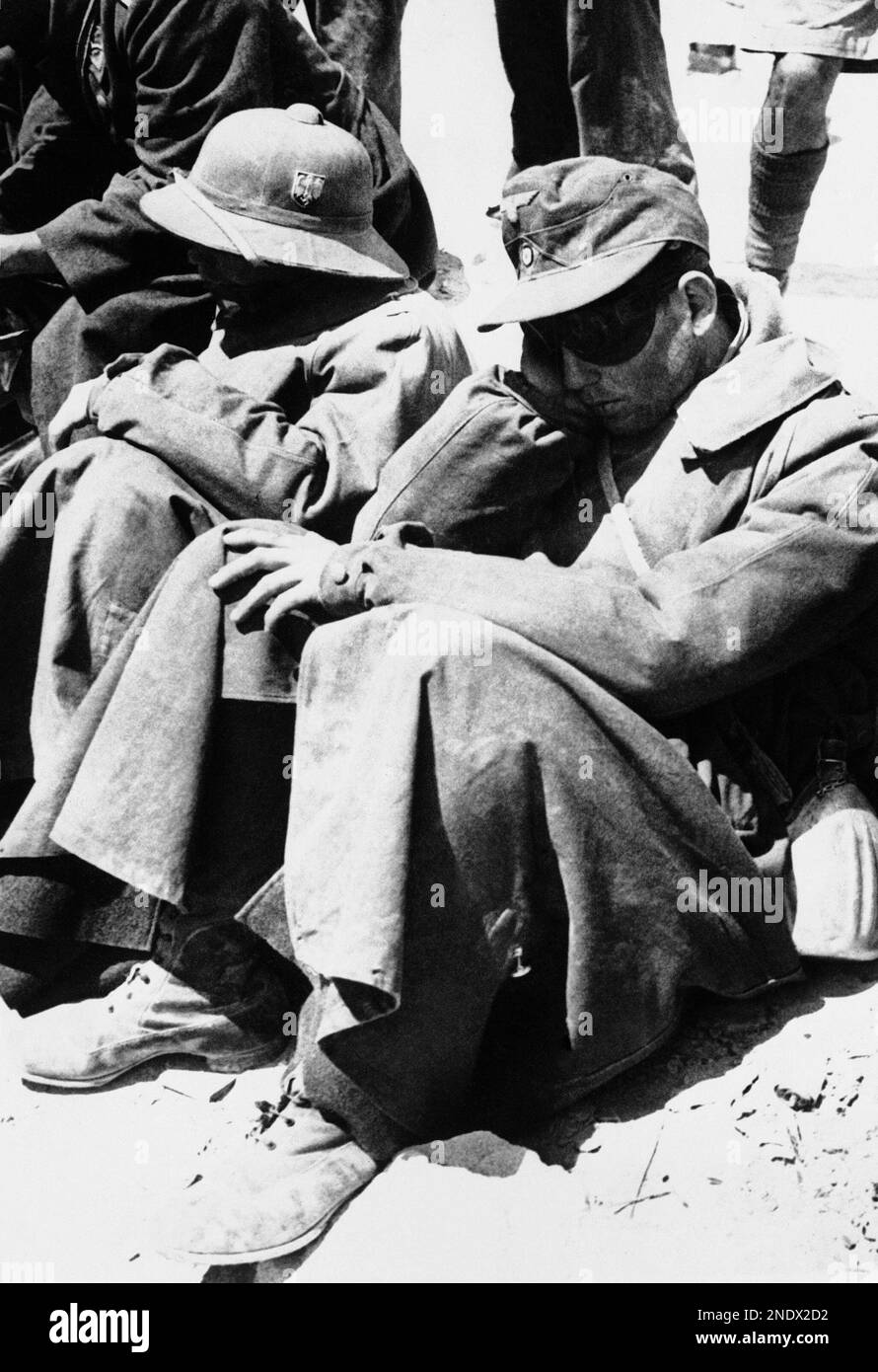 German prisoners await transportation to a concentration camp after ...