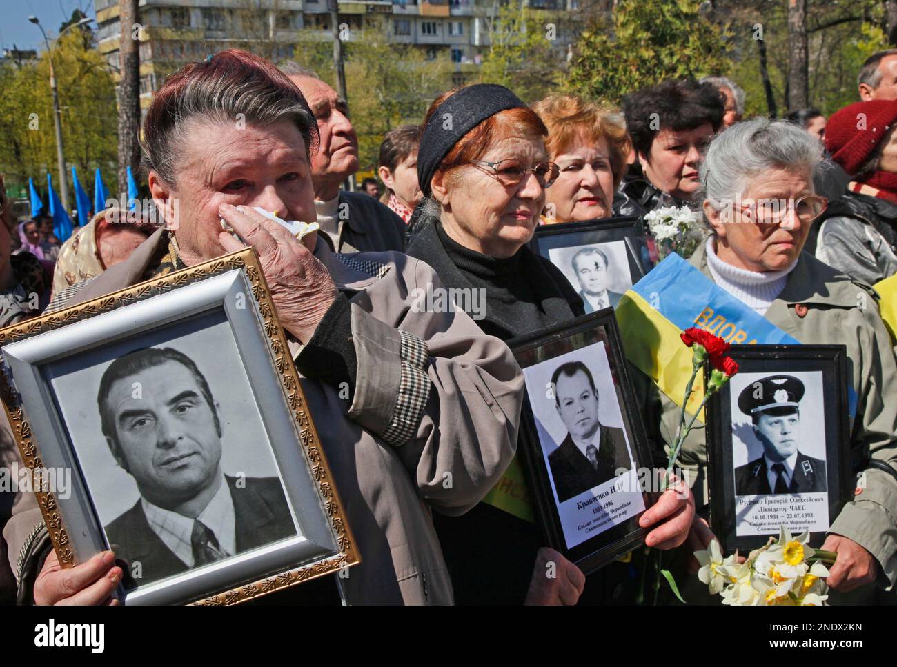 Relatives of Chernobyl victims, stand near the monument to Chernobyl ...