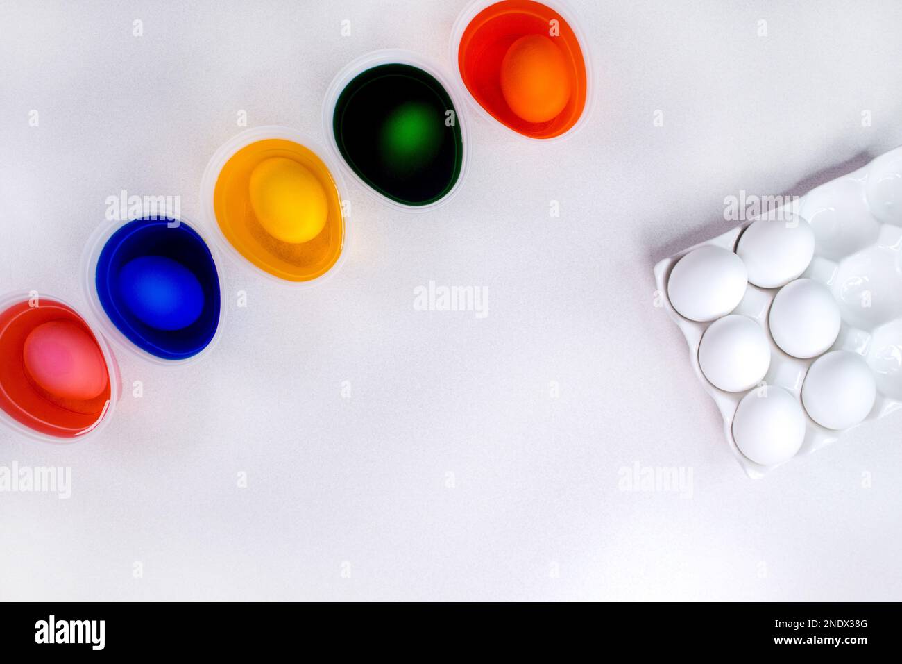 Tools for painting eggs for easter, eggs box, cups of colorful paint ...