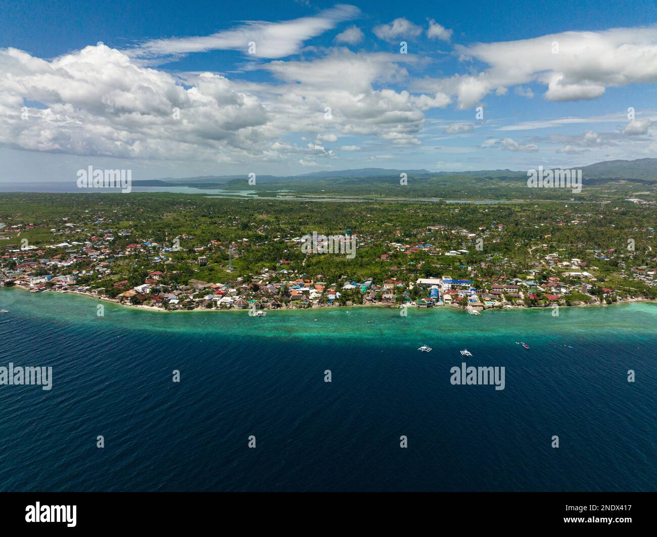 Coastline with coral reef and blue water, diving site, Moalboal ...