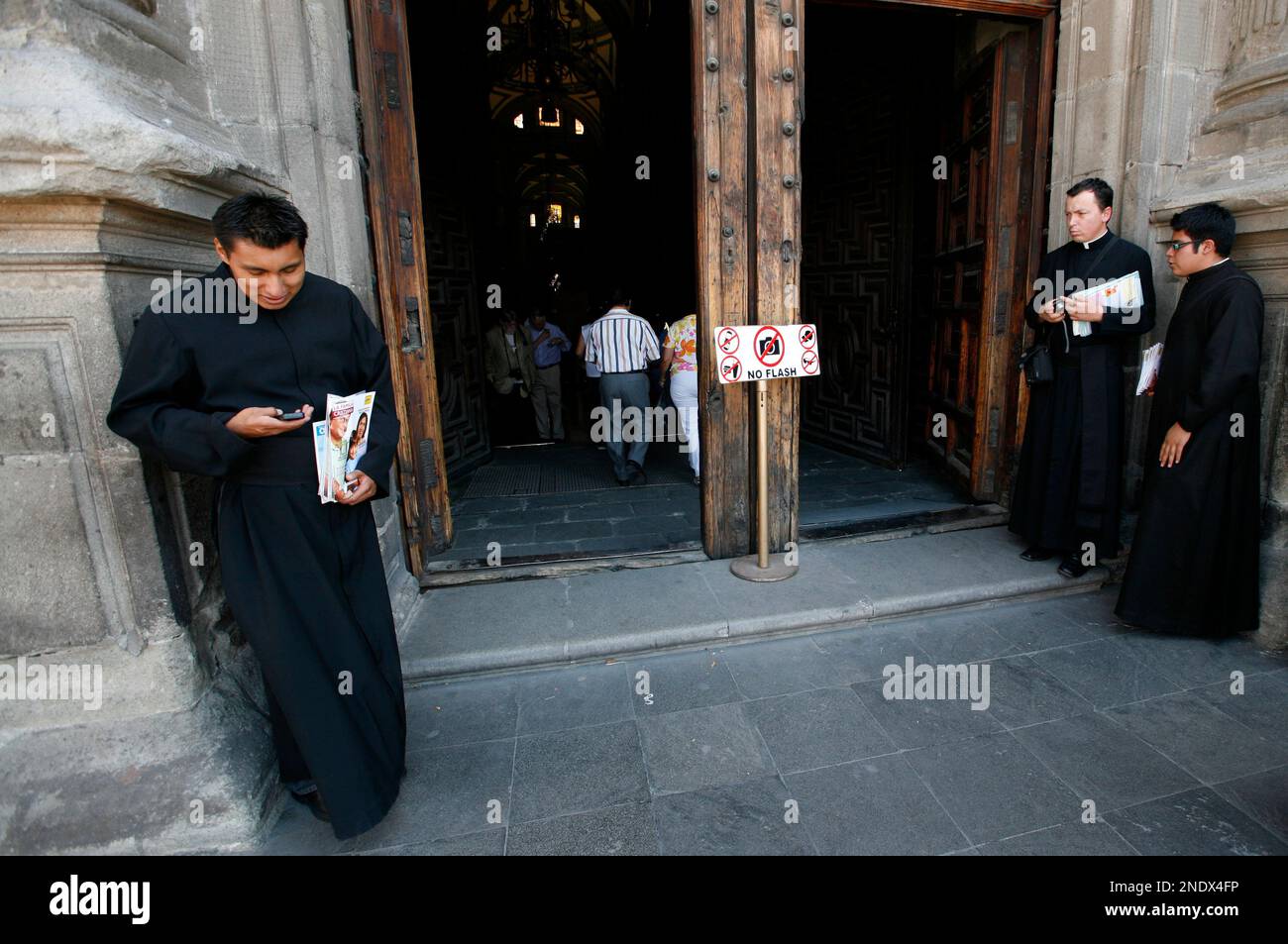 Mexican priests stand at an entrance of the Metropolitan Cathedral in ...