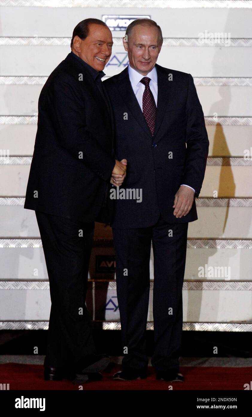 Russian Prime Minister Vladimir Putin, right, is welcomed by Italian ...