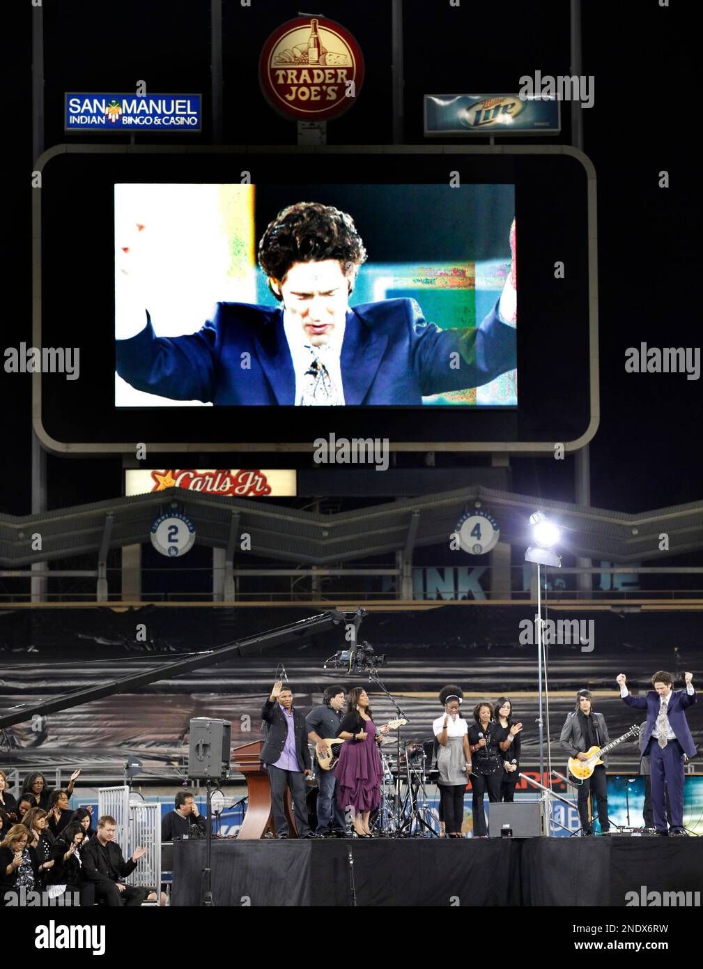 Lakewood Church pastor Joel Osteen, shown on a giant monitor and on the ...