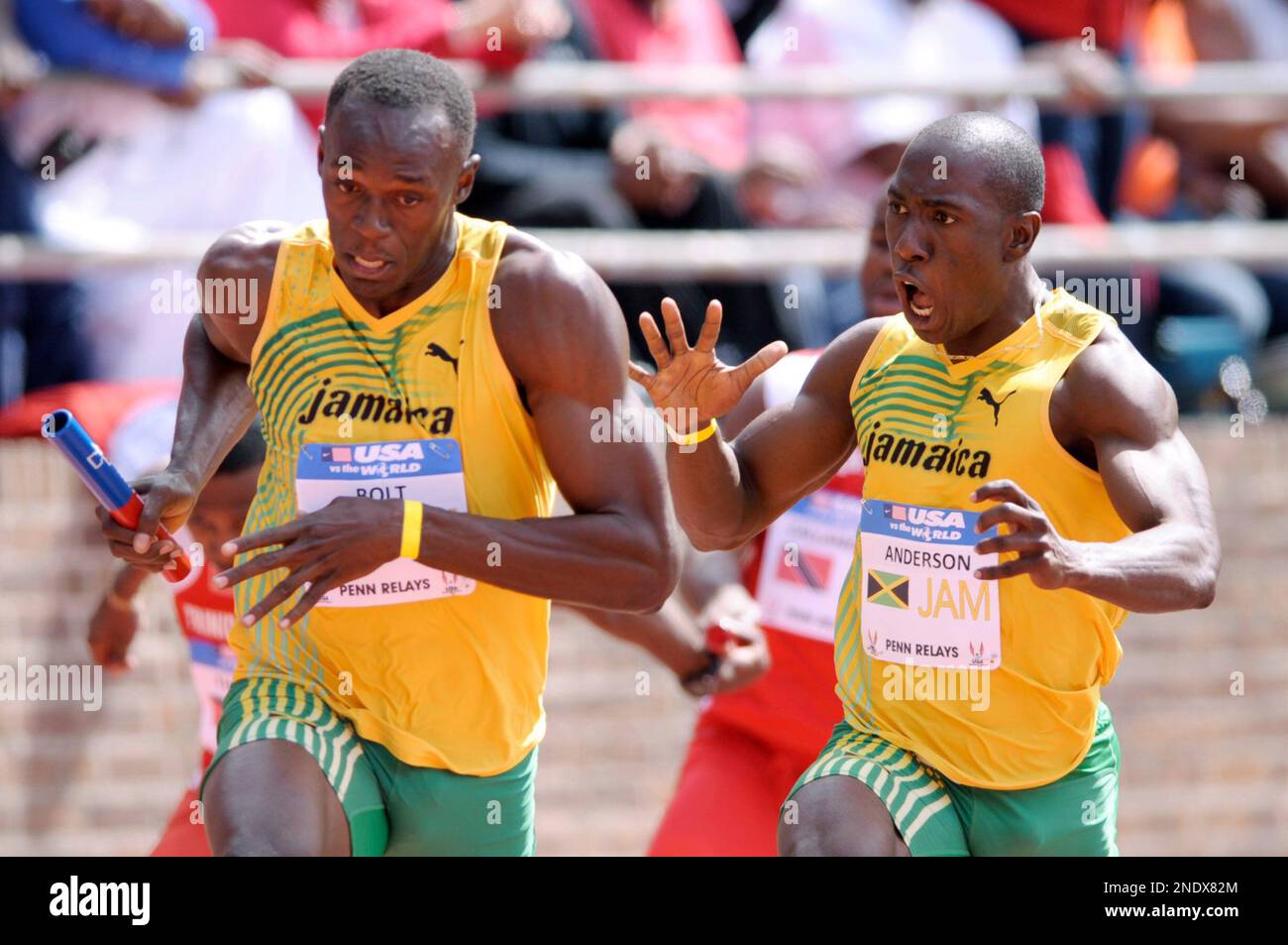Jamaican sprinter Usain Bolt, left, takes the hand off from teammate ...