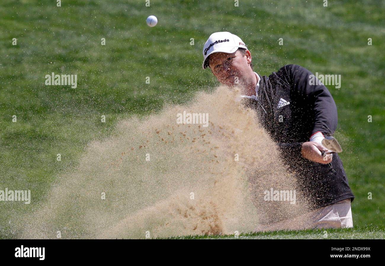 Marcus Fraser of Australia blasts out from a bunker on the 8th hole ...