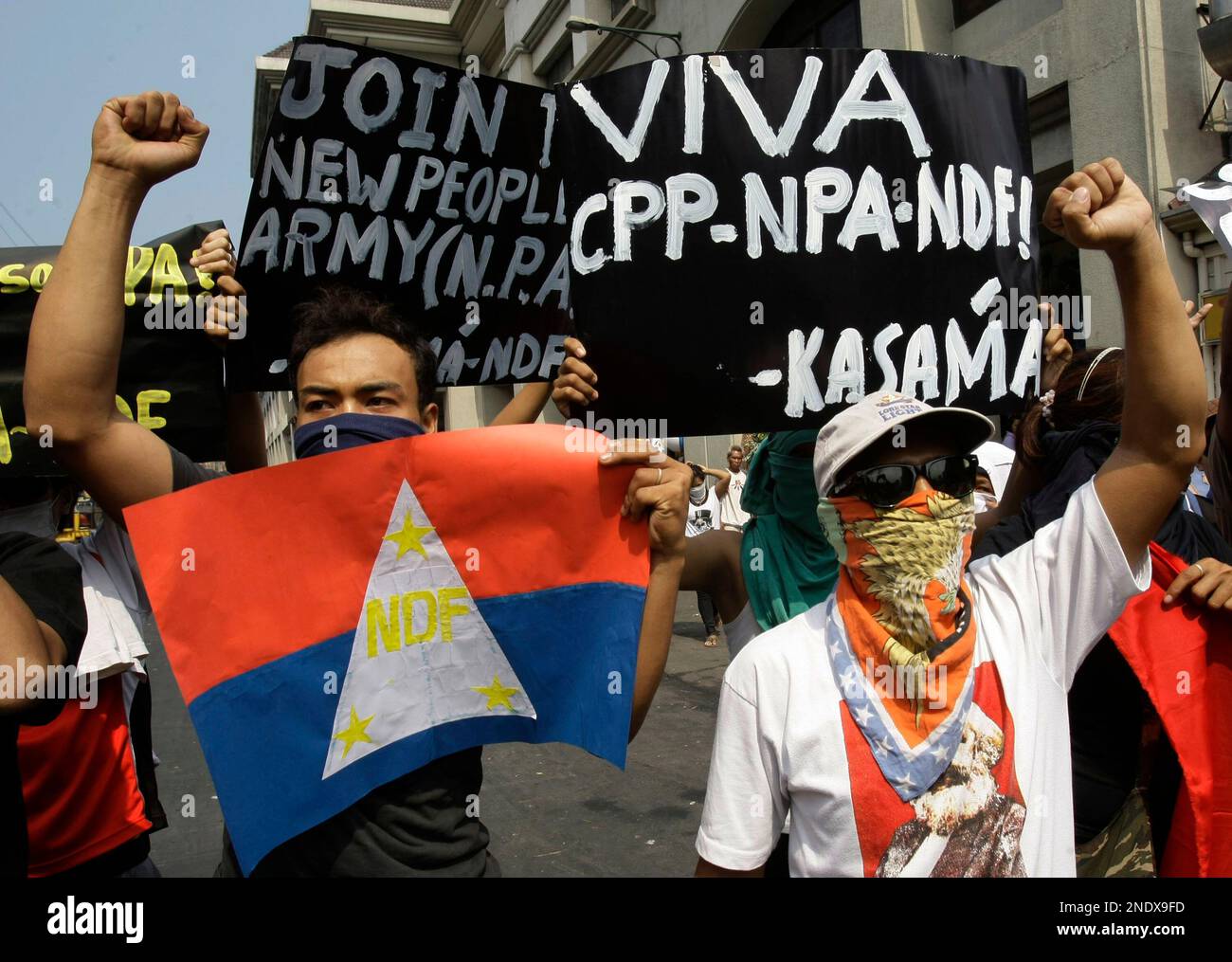 Masked members of the communist National Democratic Front display their ...