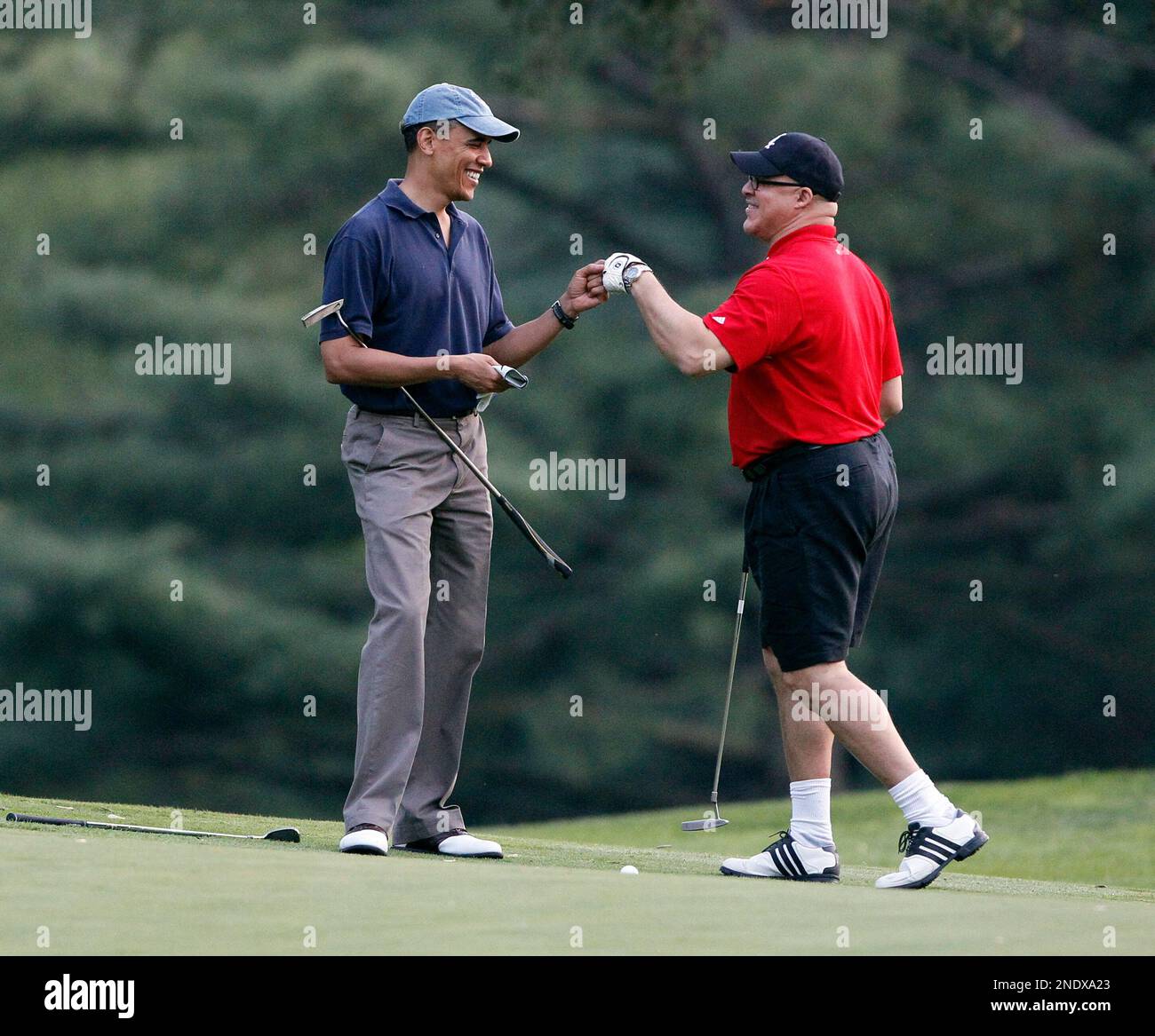 President Barack Obama, left, fist bumps with Dr. Eric Whitaker on the ...