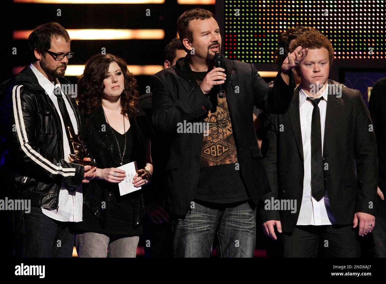 Mark Hall, center, and the group Casting Crowns accept the artist of ...
