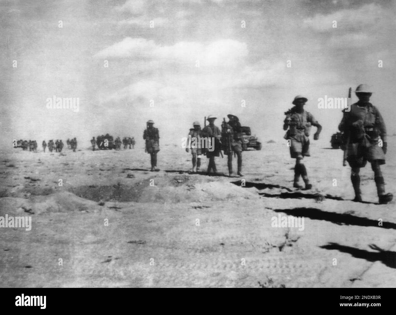 Infantry and vehicles of the Allied forces move ahead through gaps just ...