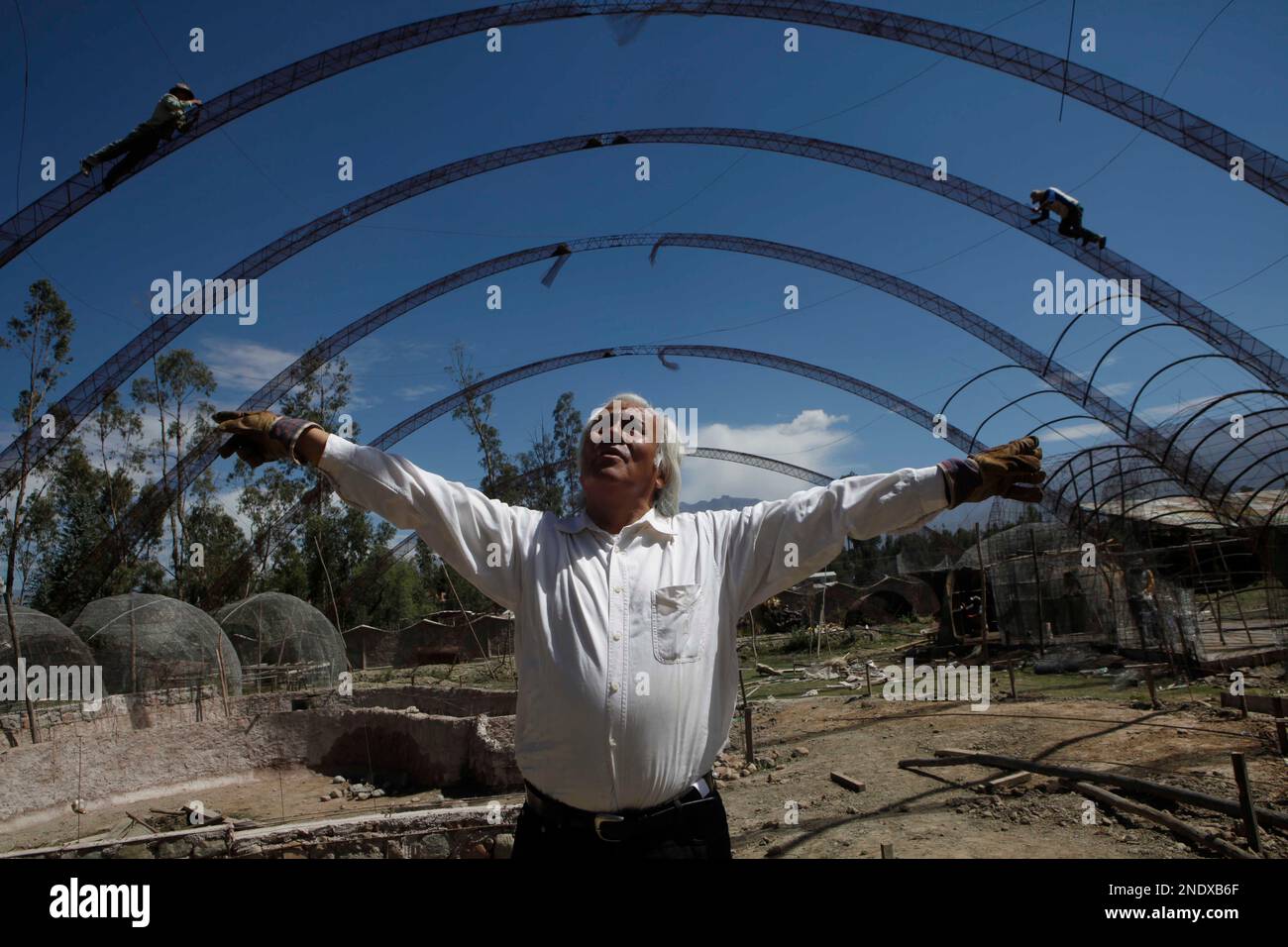 Architect Mario Moscoso gives instructions to workers building a dome ...