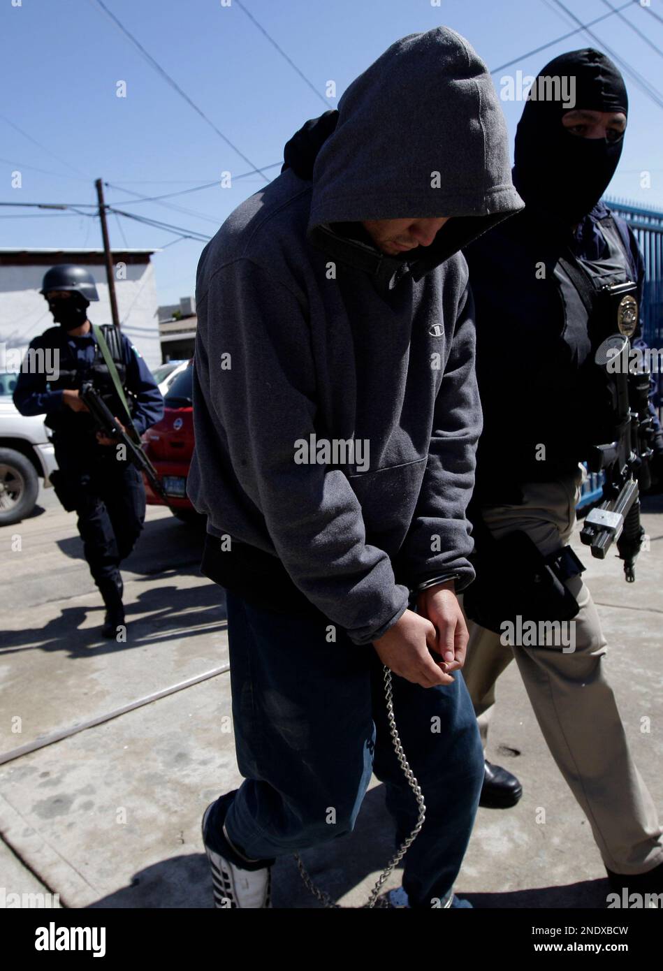 Aaron Barragan is escorted by police in Tecate, Mexico, Friday, April ...