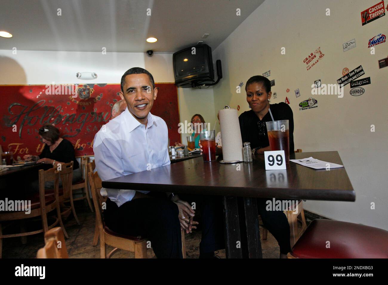 President Barack Obama and first lady Michelle Obama sit a table and ...