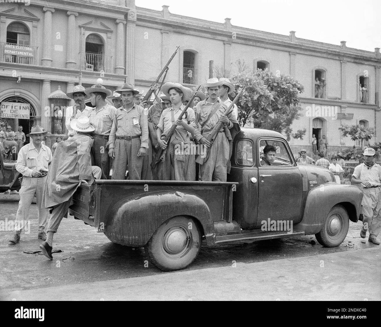 Troops load in truck on the way to Zacapa and the front on July 5, 1954 ...