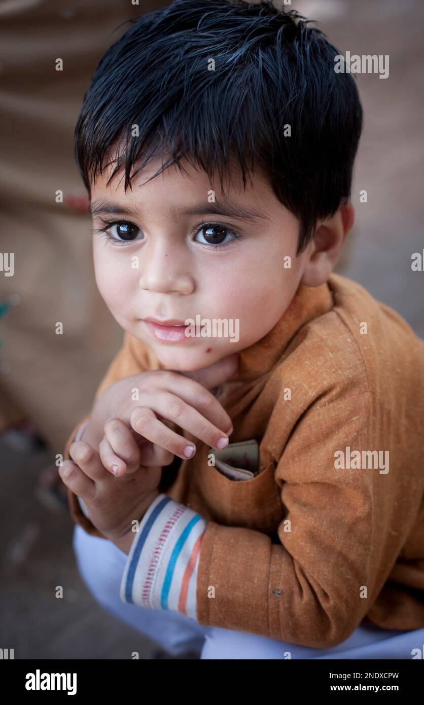 A Pakistani boy waits to receive a ration of donated rice at the Sufi ...