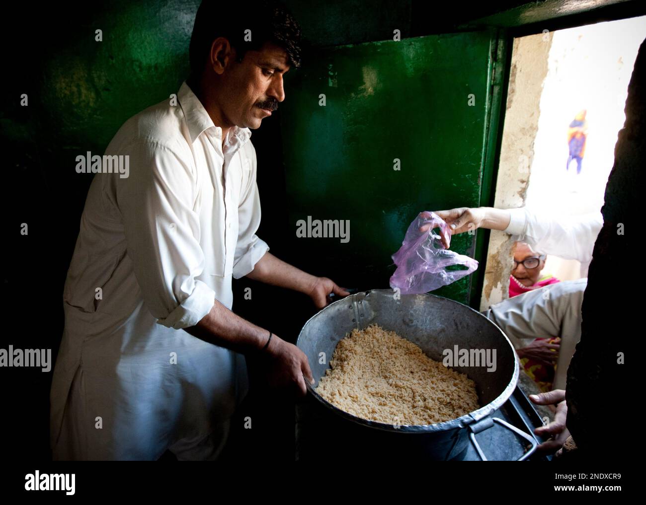 A Pakistani man at the Sufi shrine Beri Iman food distribution center ...