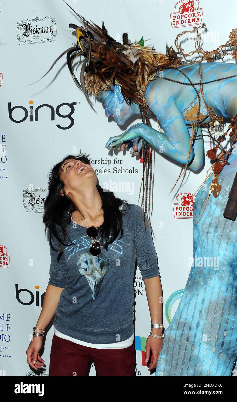 Michelle Rodriguez, at left arrives at The Green Carpet and Home Tree ...