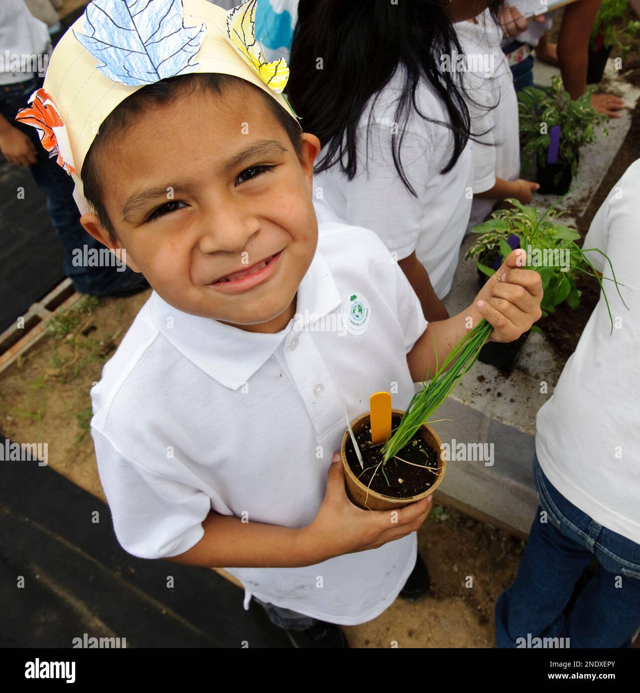 A first grader prepares to plant herbs during Doubletree Hotels ...