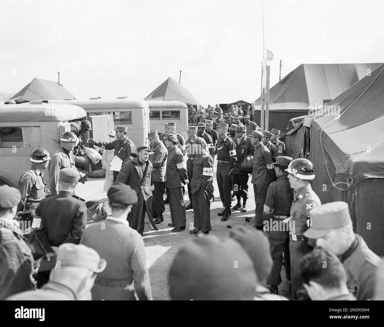 U.N. and Red officials check U.N. prisoners of war as they climb out of ...