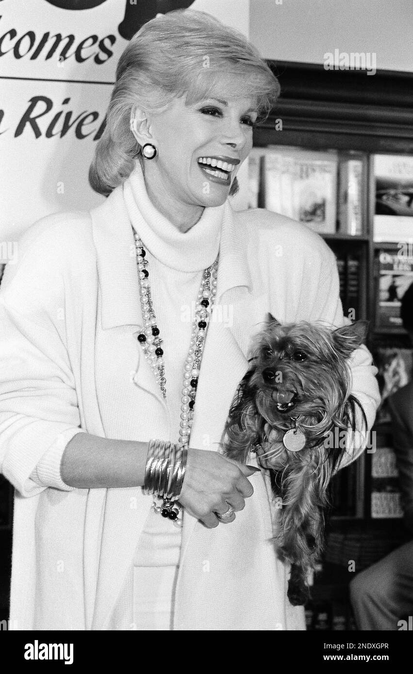 Comedienne Joan Rivers arrives carrying Spike at a Cambridge, Mass ...