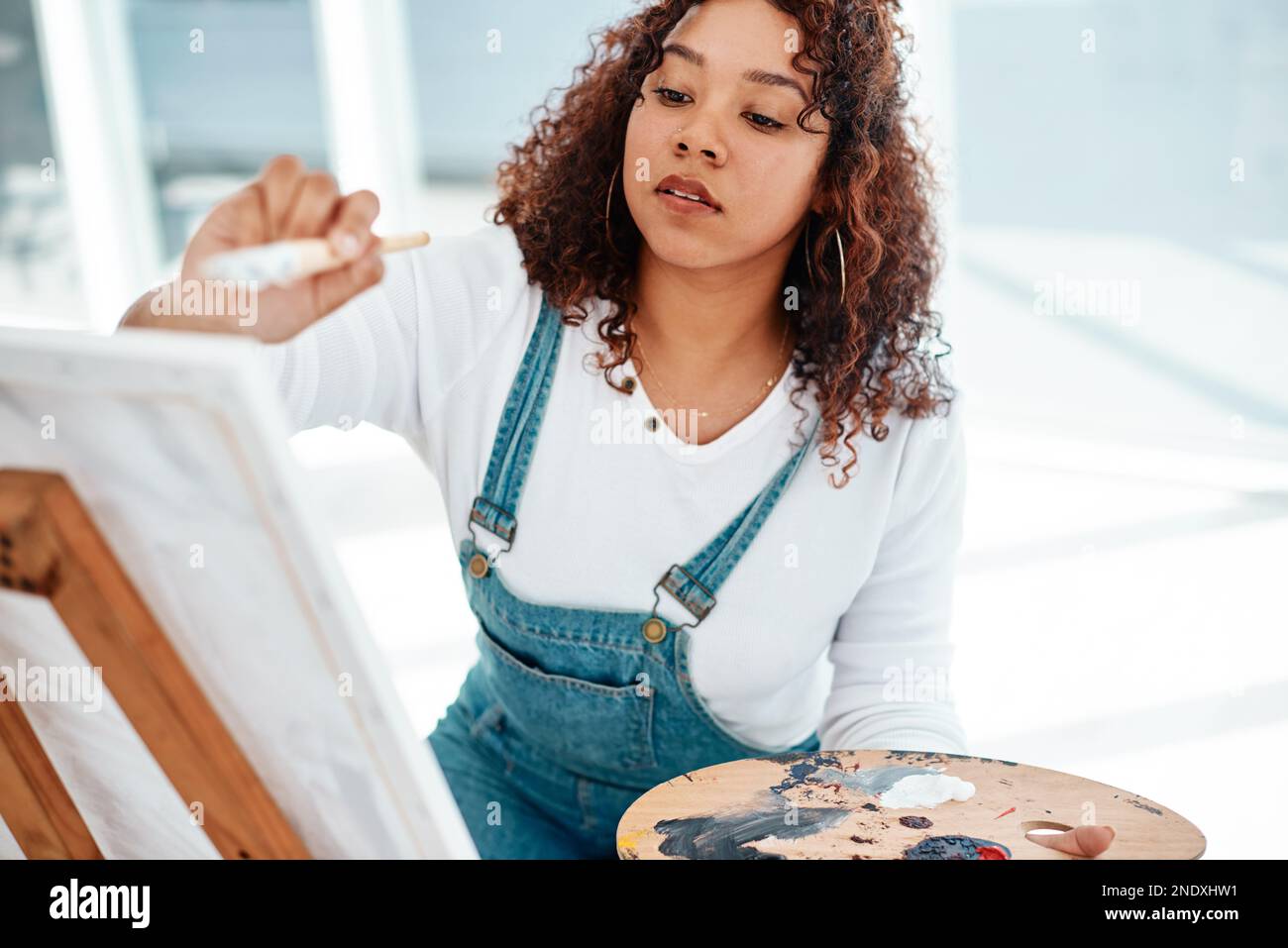 Dare to show your creative side. an attractive young artist sitting ...