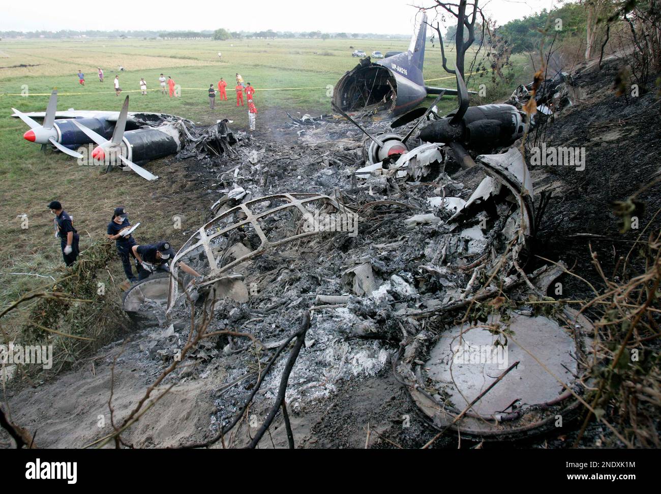 Investigators check the remains of an Antonov 12 aircraft that crashed ...